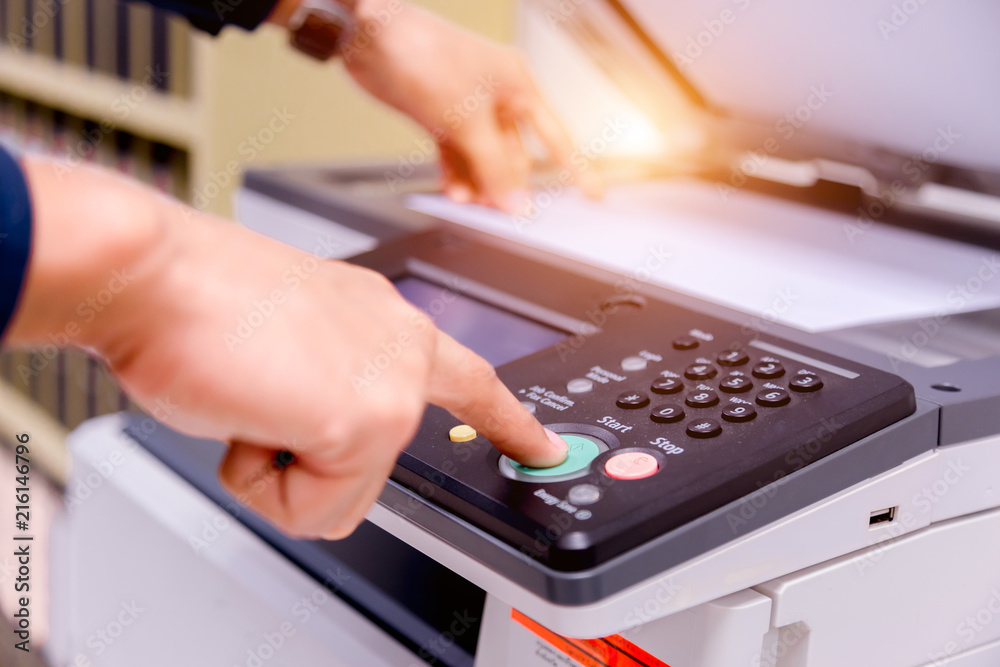 Bussiness man Hand press button on panel of printer, printer scanner ...