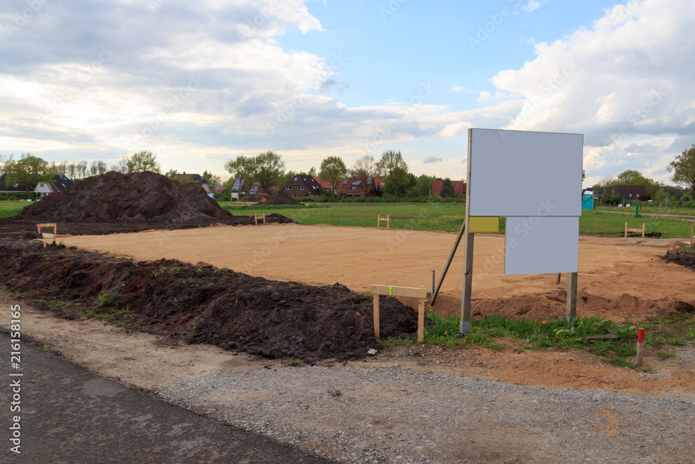 Construction site for one family house filled with sand and empty sign ...