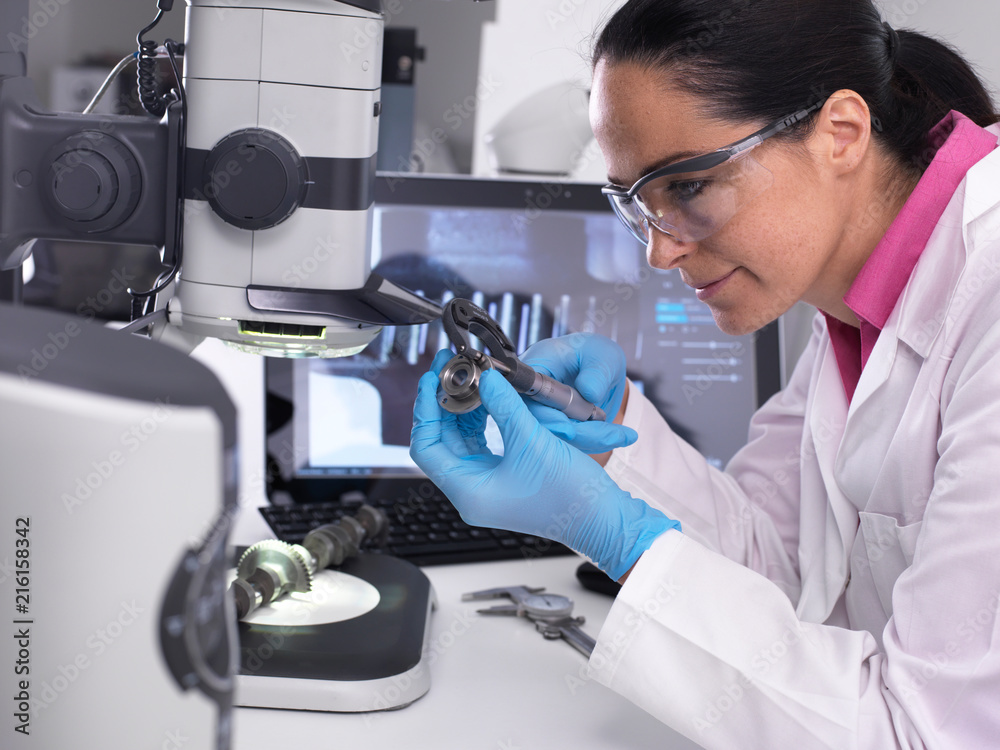 Engineer measuring manufactured component for accuracy and quality ...