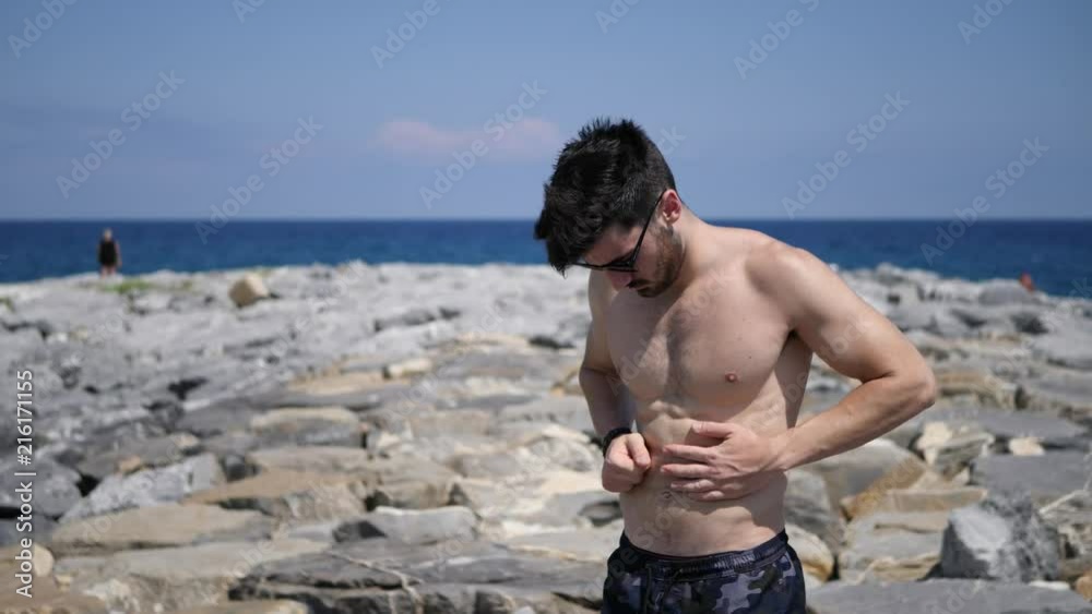 Shirtless Young Man Putting on Sunscreen Cream, Muscular Man Wearing ...