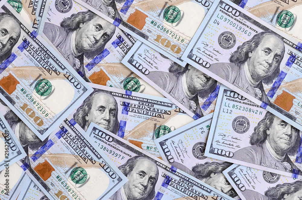 A large number of US dollar bills of a new design with a blue stripe in ...