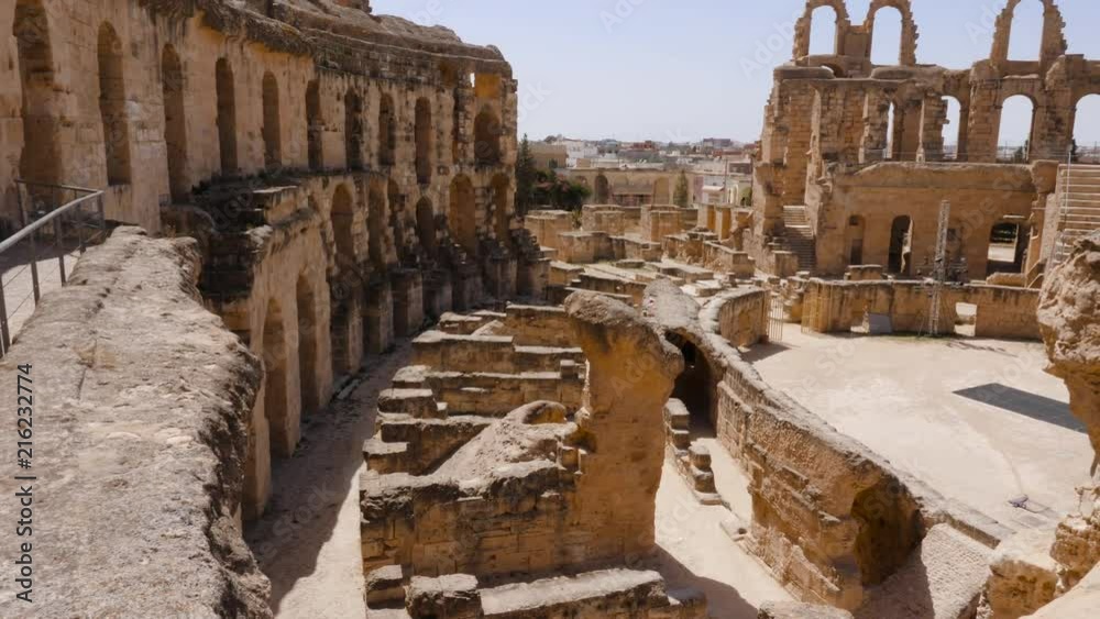 Ruins of Amphitheatre of El Jem with arena, columns and brick walls ...