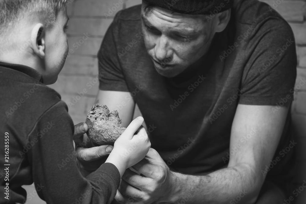 Little child giving piece of bread to homeless poor man Stock Photo ...