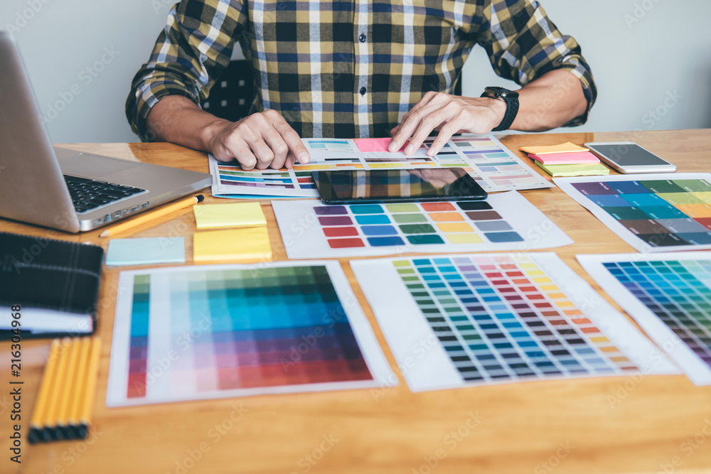 Young creative Graphic designer using graphics tablet to choosing Color ...