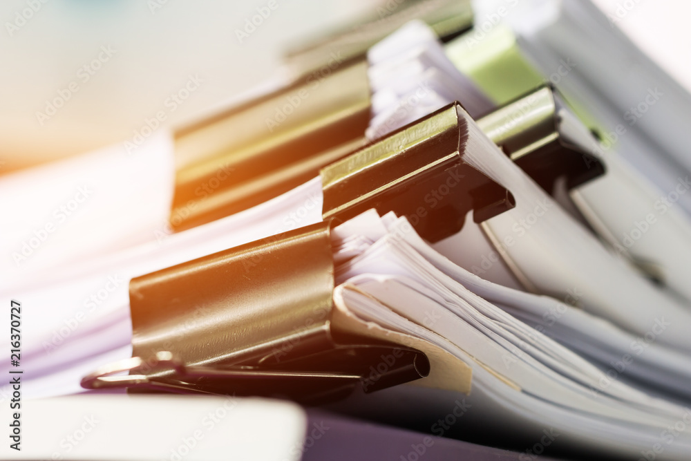Unfinished documents stacks of paper files on office desk for report ...