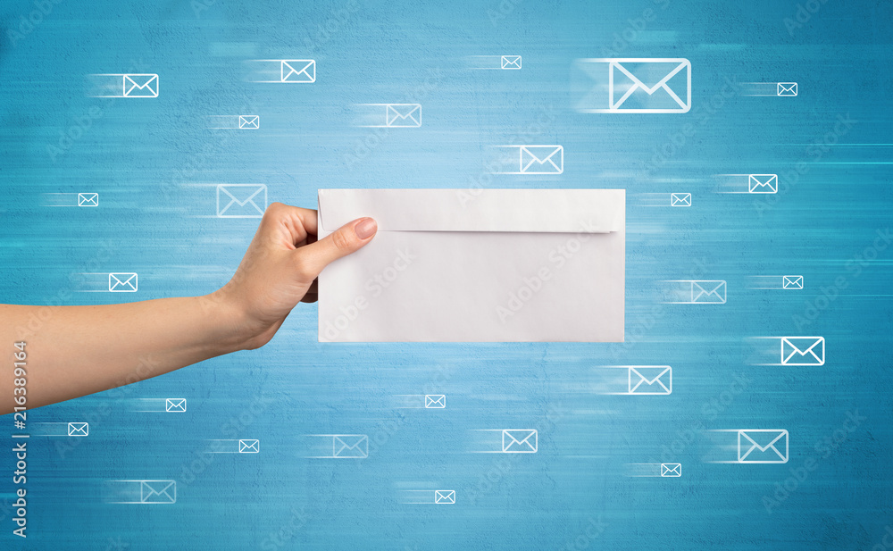 Female hand holding coloured and white envelope with blue background ...