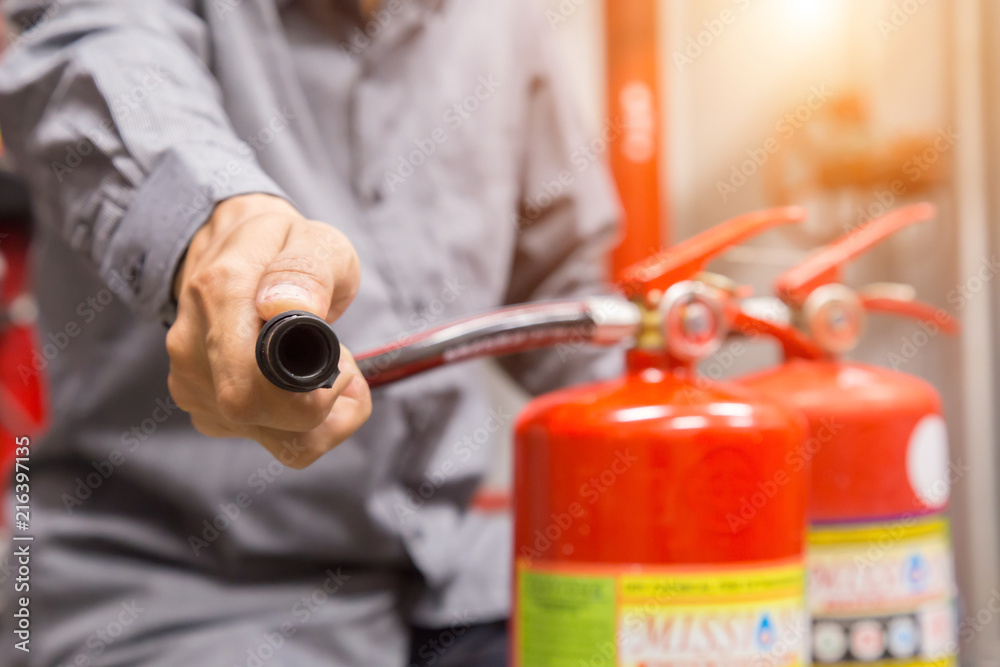Engineer inspection Fire extinguisher in control room. Stock Photo ...