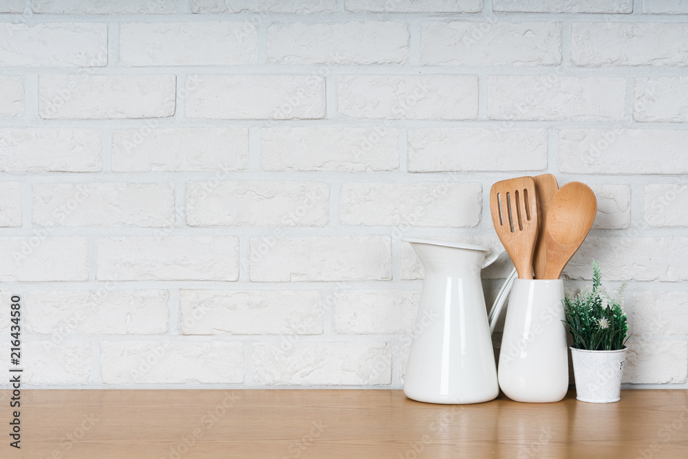 There are various cookers on the table, background made of bricks ...