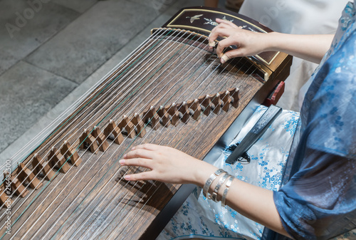 hand of man playing Guzheng.The guzheng or gu zheng, also simply called ...