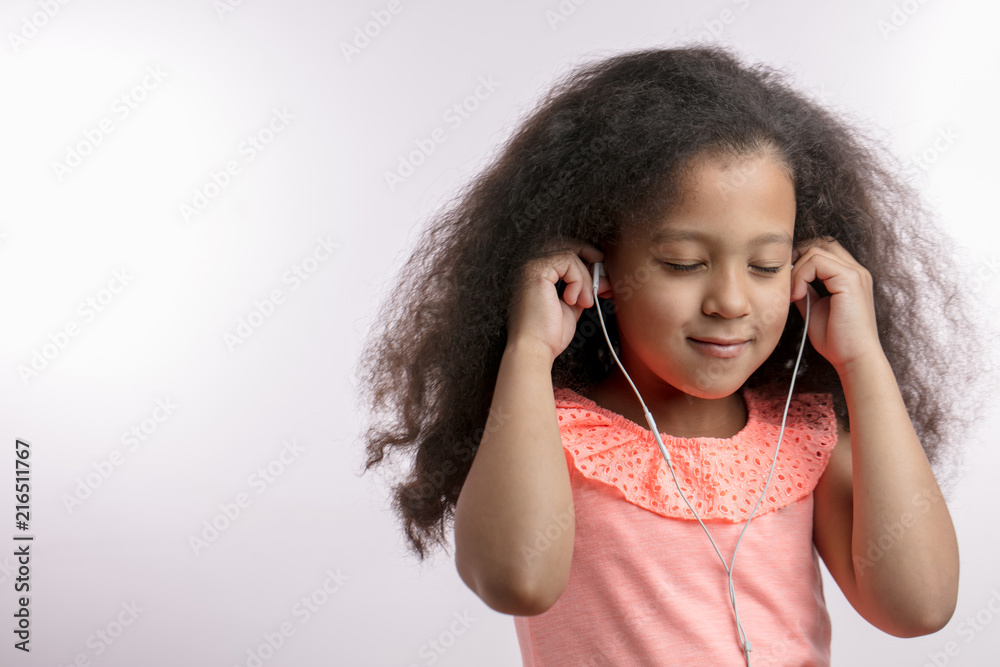 awesome kid with long black wavy hair is listening to her favourite ...