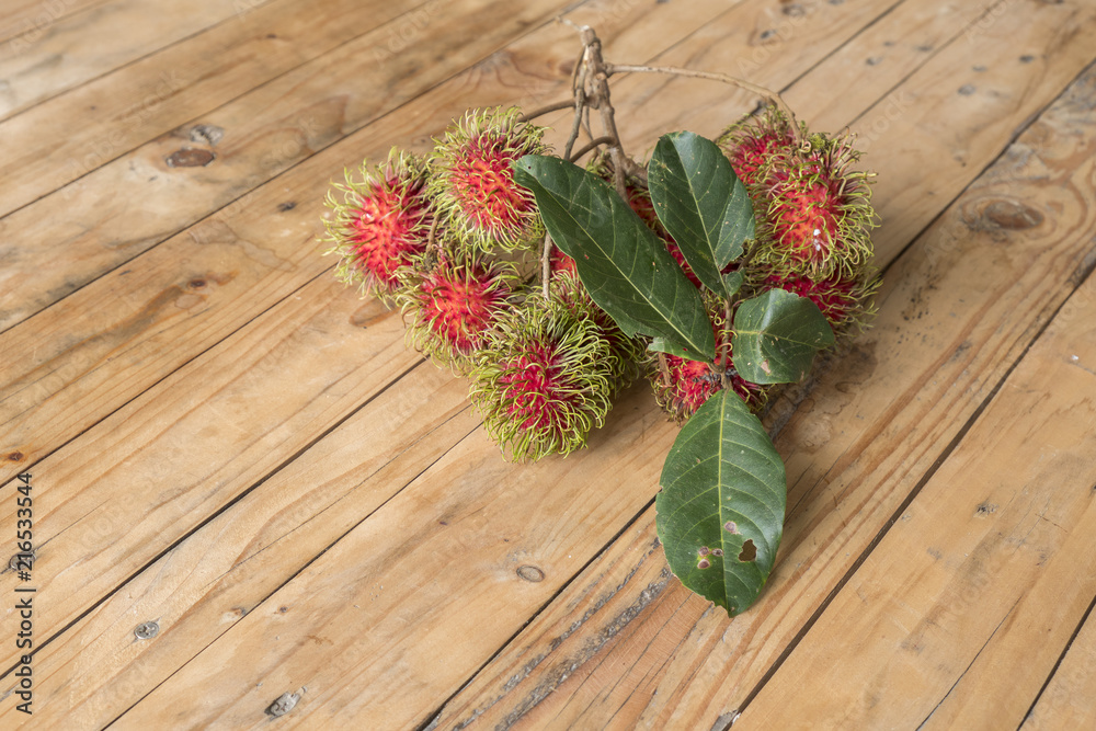 Red rambutan Nephelium lappaceum on broun board. Fruit tropical tree of ...