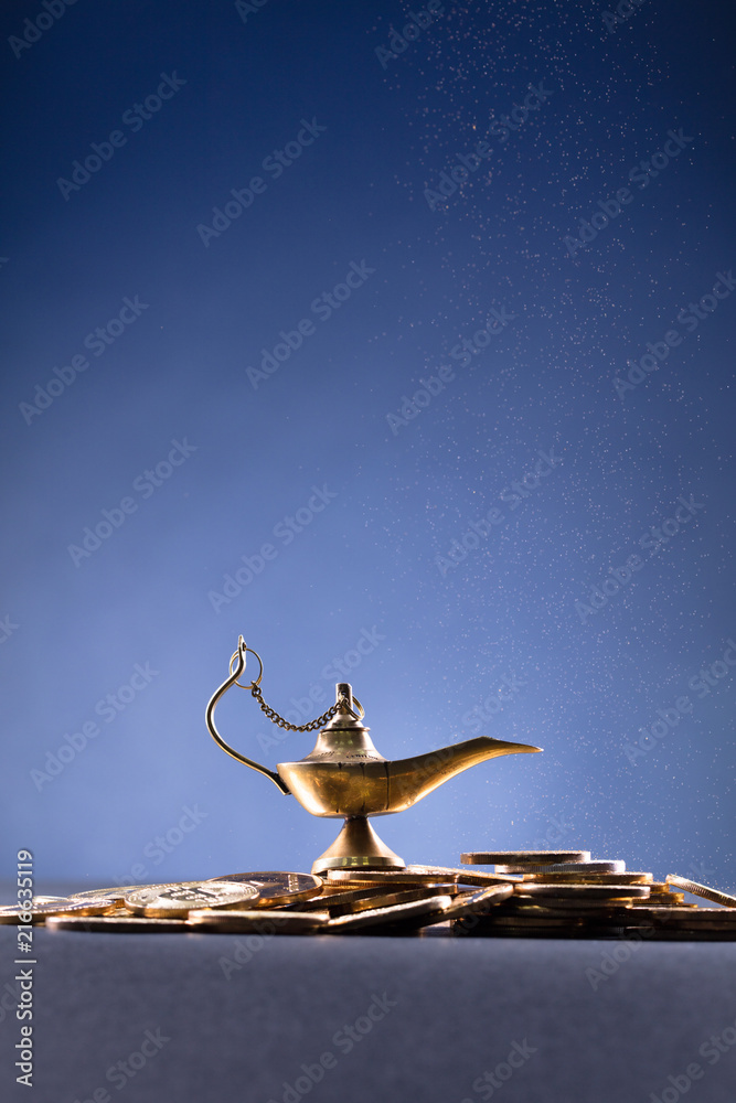 Magic lamp of wishes on stacks of gold coins with smoke coming out from ...