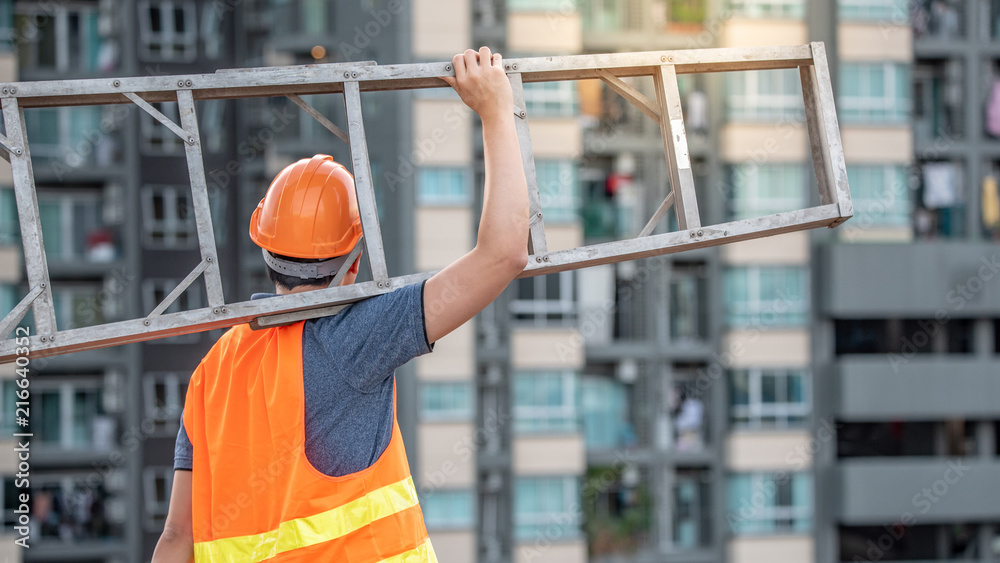 Young Asian maintenance worker man with orange safety helmet and vest ...