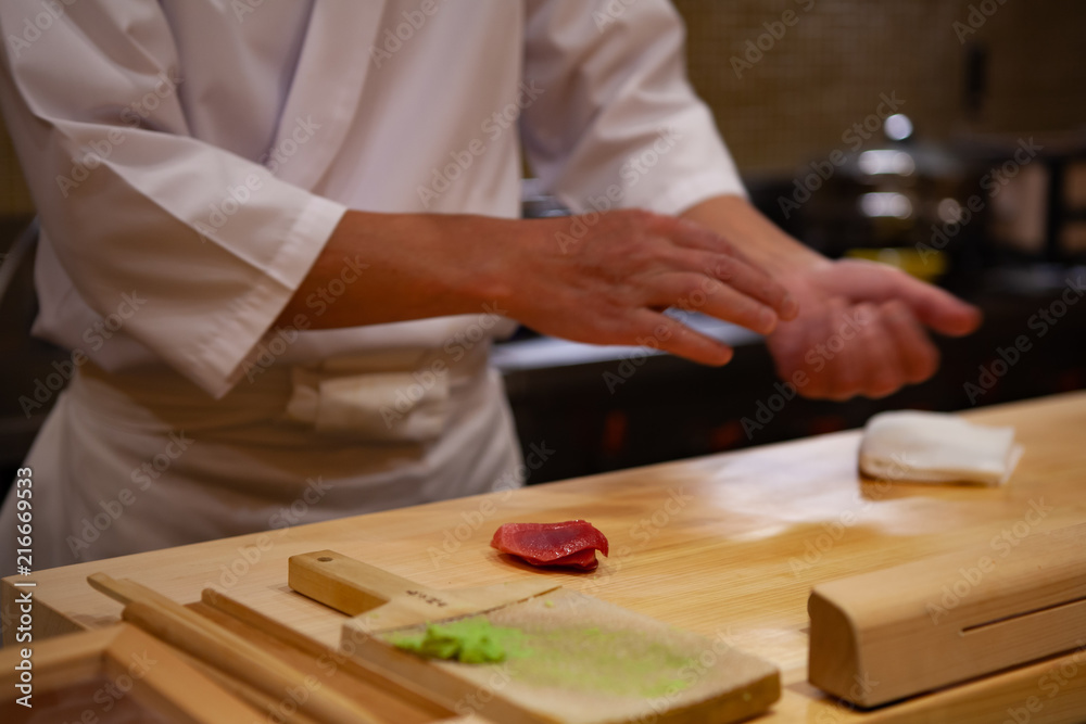 Professional sushi chef carefully using just the right pressure to make ...