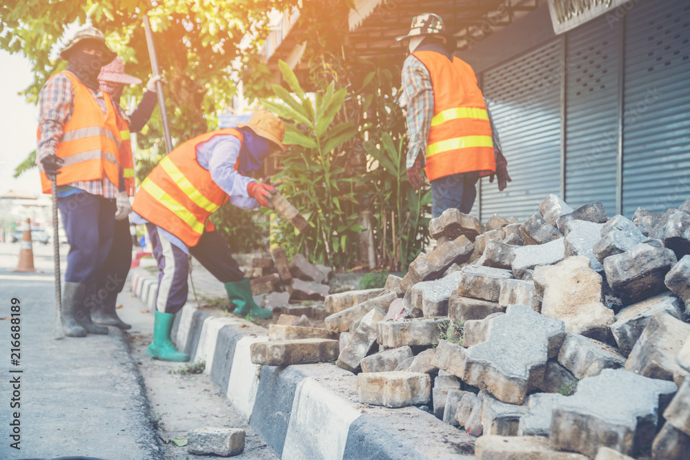 labors are constructing pedestrian walkways; workers building and ...