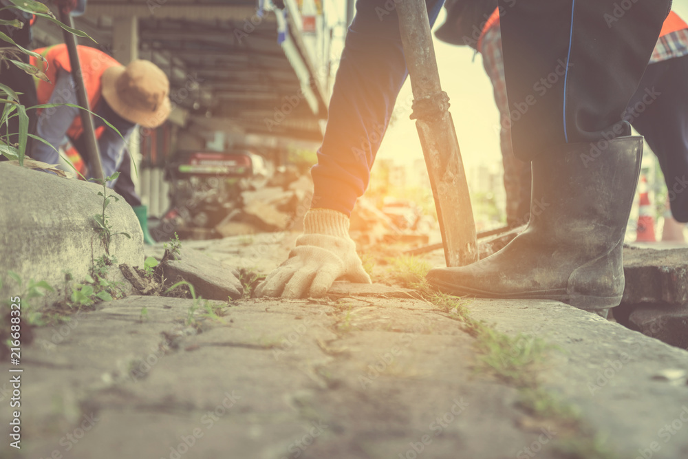 labors are constructing pedestrian walkways; workers building and ...