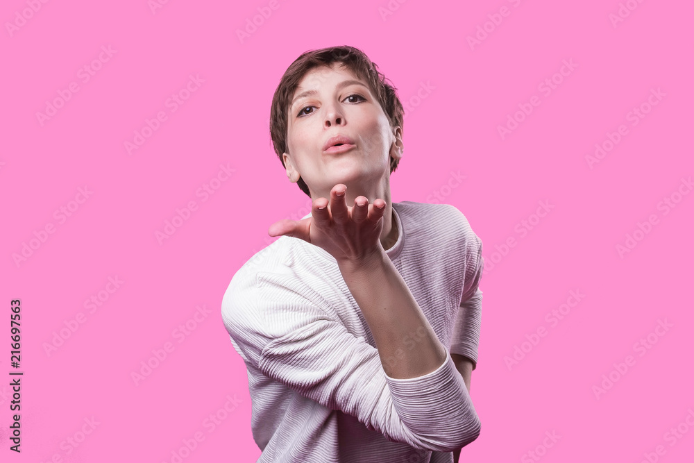 I kiss you. Portrait of attractive woman with kiss on lips. Pink studio ...