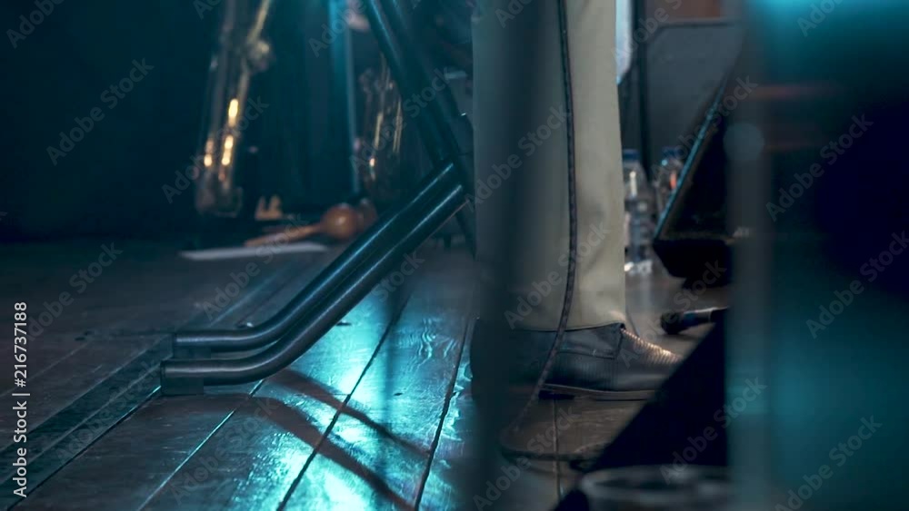 Singer tapping his feet on the beat of the music while on stage. Shot ...