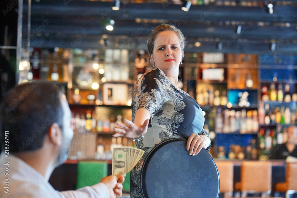 The waitress does not take the tip. The waitress refuses to receive a ...
