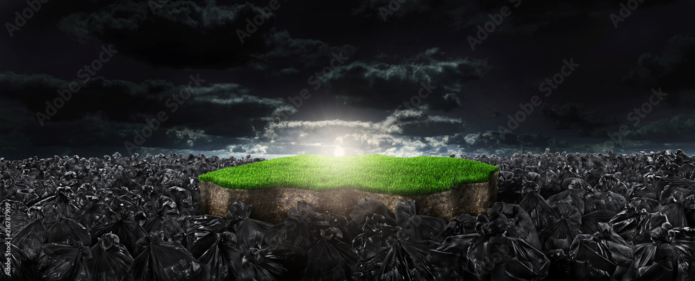 Concept of pollution. A garbage dump with a piece of ground on a gloomy ...