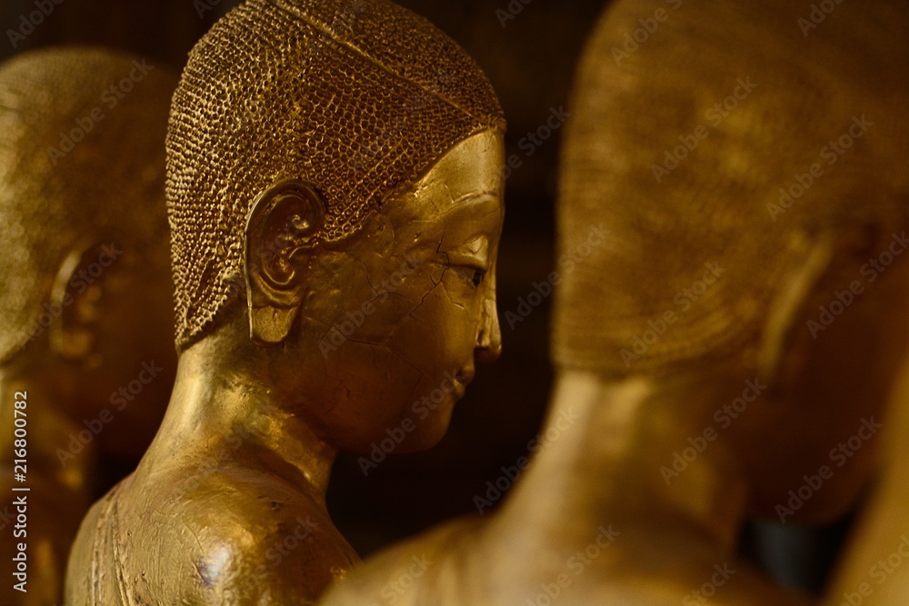 Ordained female monks or Bhikkunis surround Buddha's sculpture.These ...