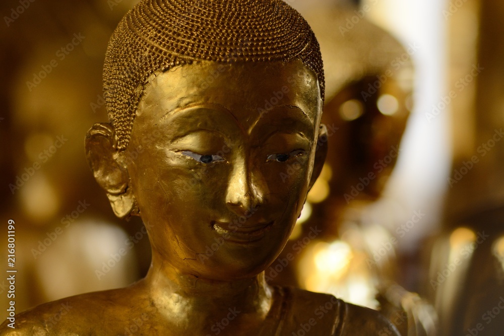 Ordained female monks or Bhikkunis surround Buddha's sculpture.These ...