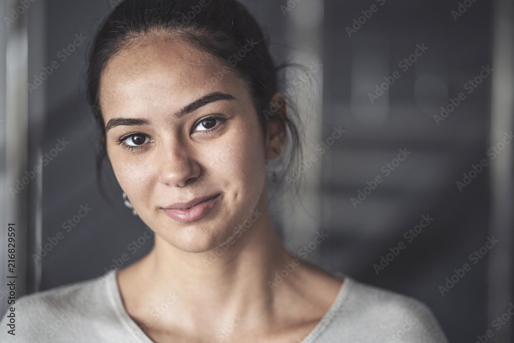 Beautiful young girl looking at camera portrait Stock Photo | Adobe Stock