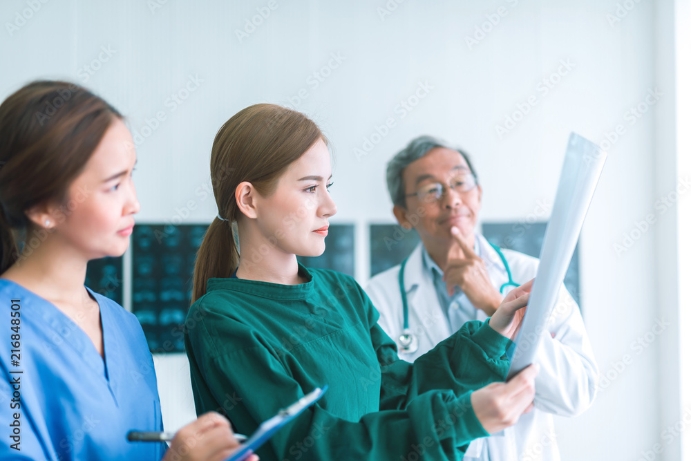Medical doctors looking at x-rays in a hospital .checking chest x ray ...