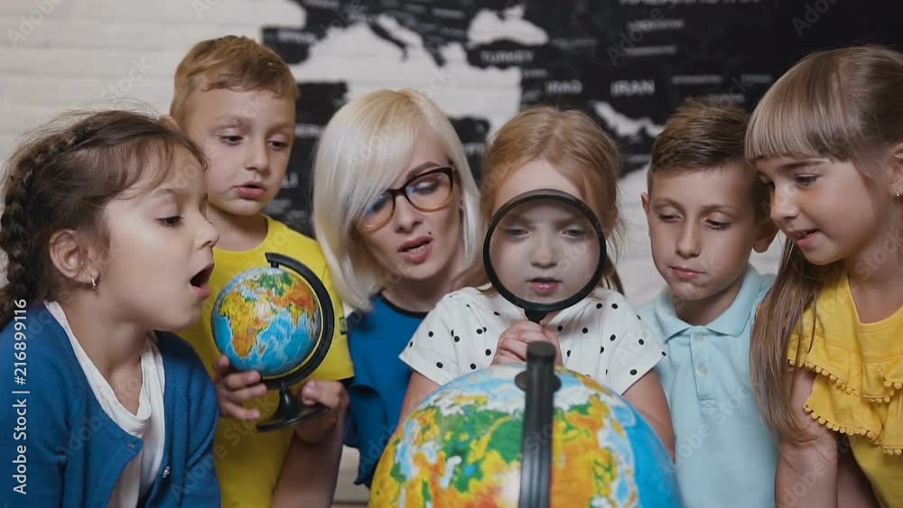 Close-up of a boys, girls and their youn teacher who are studying the ...