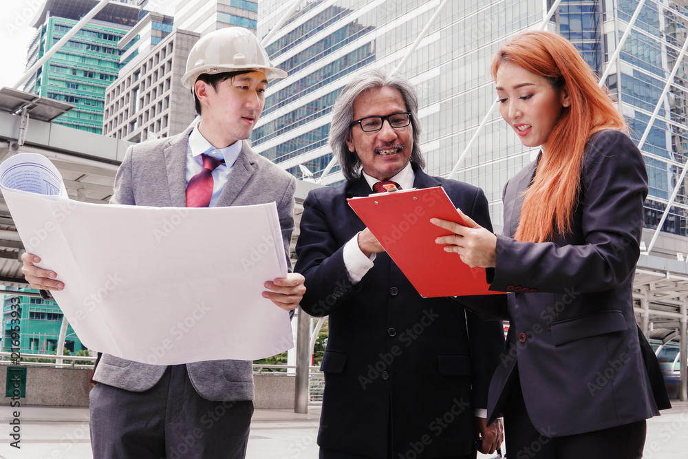 Executives, enjineer and secretaries are discussing and viewing the ...