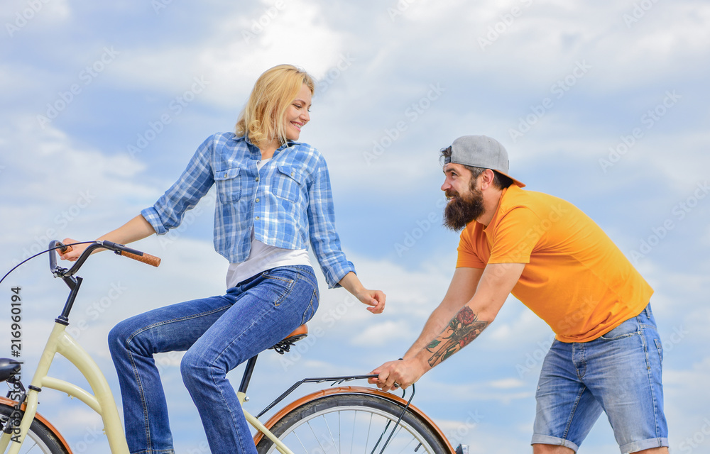 Support and friendship. Woman rides bicycle sky background. Service and ...