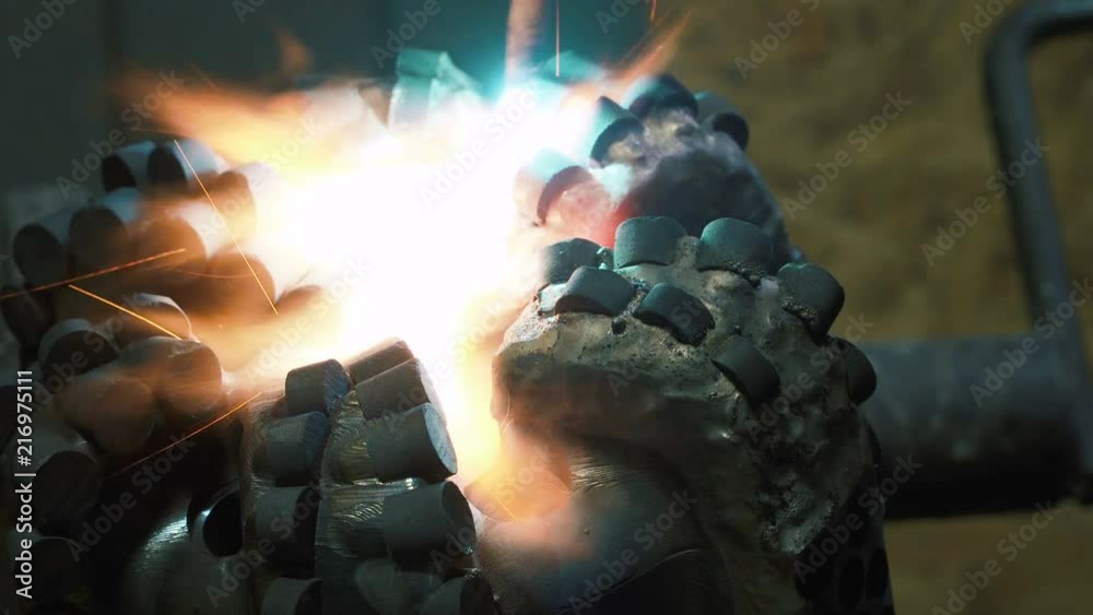 Welder welds the parts of the metal structure. Manufacture of drills ...
