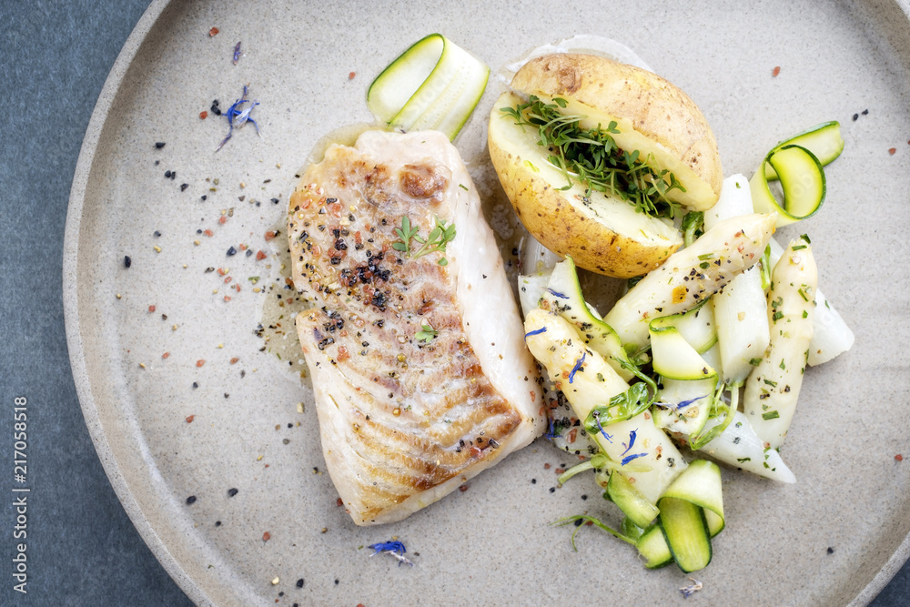 Modern German fried cod fish filet with white asparagus tips and roast ...