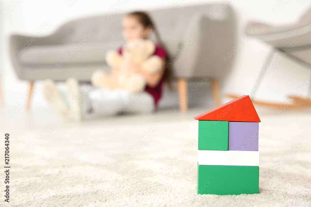 House made from cubes and little girl with autistic disorder on ...