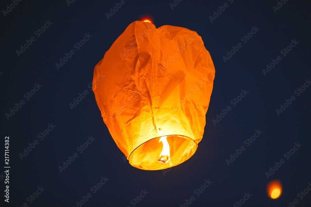 Flying lantern in the dark sky Stock Photo | Adobe Stock