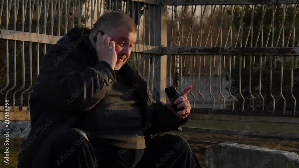 Fat man talking on the phone and very nervous on city street. Obesity ...