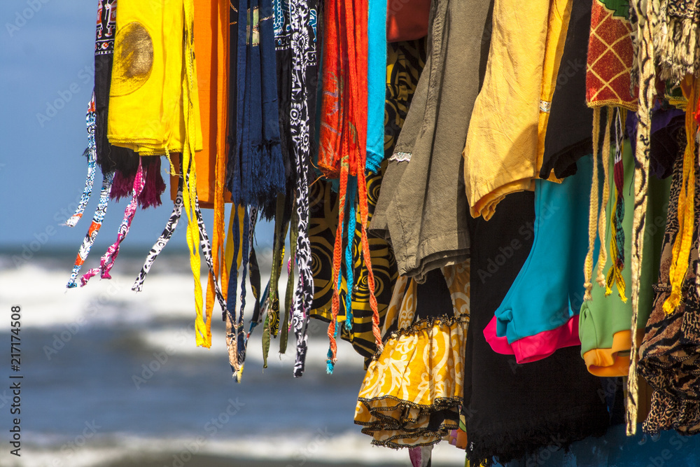 Street vendor of clothes, swimsuits, bikinis and cangas on a beach in ...