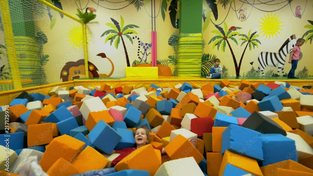 Dolly shot of adorable little girl of elementary school age falling ...