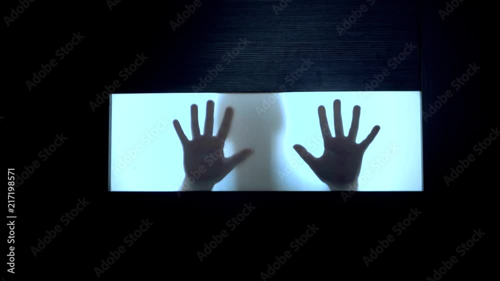 Possessed girl scratching glass with hands, creepy female silhouette ...