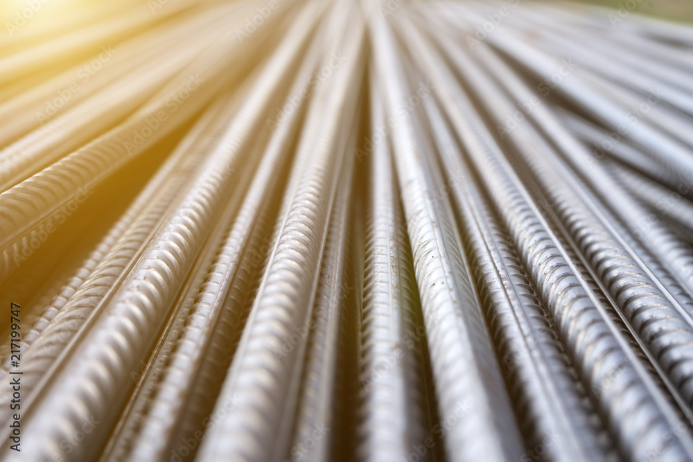 Stack of heavy metal reinforcement bars with periodic profile texture ...