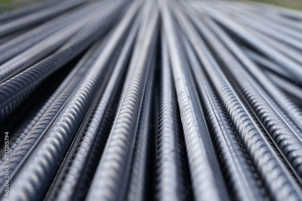 Stack of heavy metal reinforcement bars with periodic profile texture ...