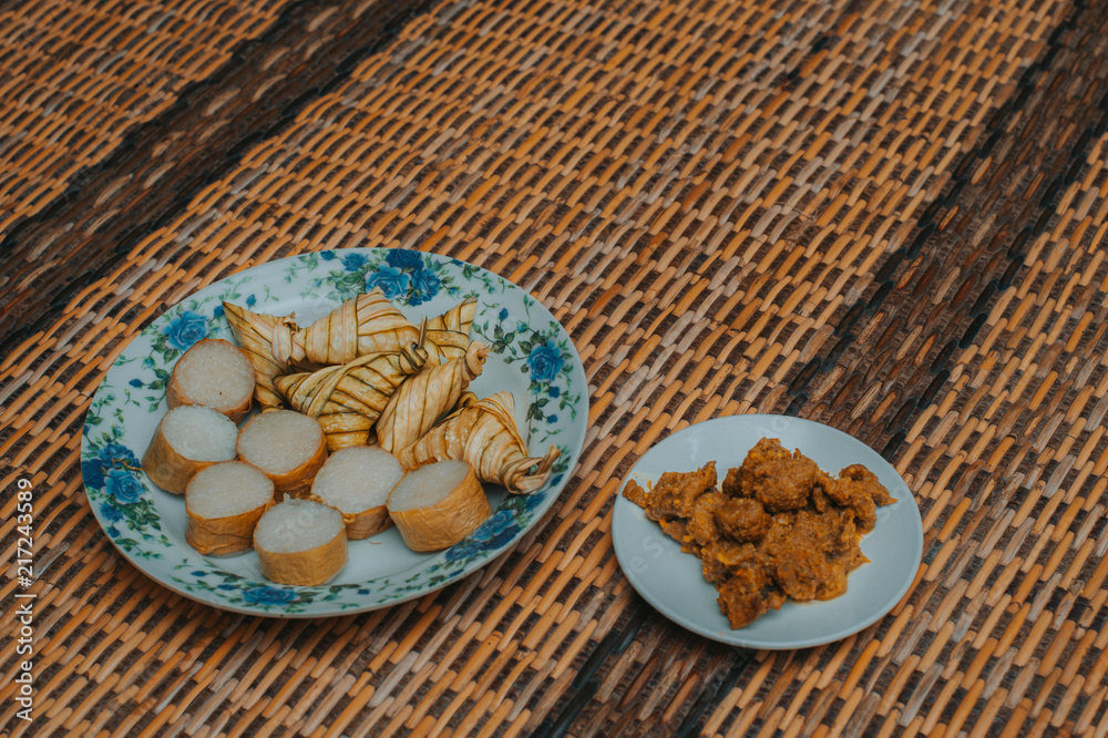 Lemang and ketupat (bamboo rice and rice dumpling) with rendang on ...