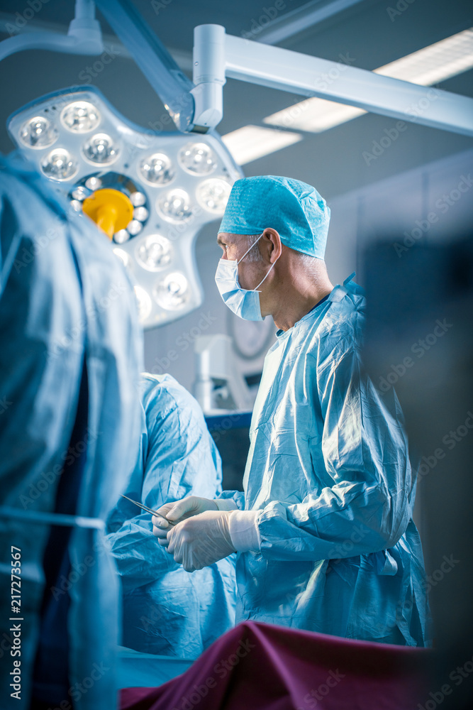 Portrait of the Professional Surgeon Performing Invasive Surgery on a ...