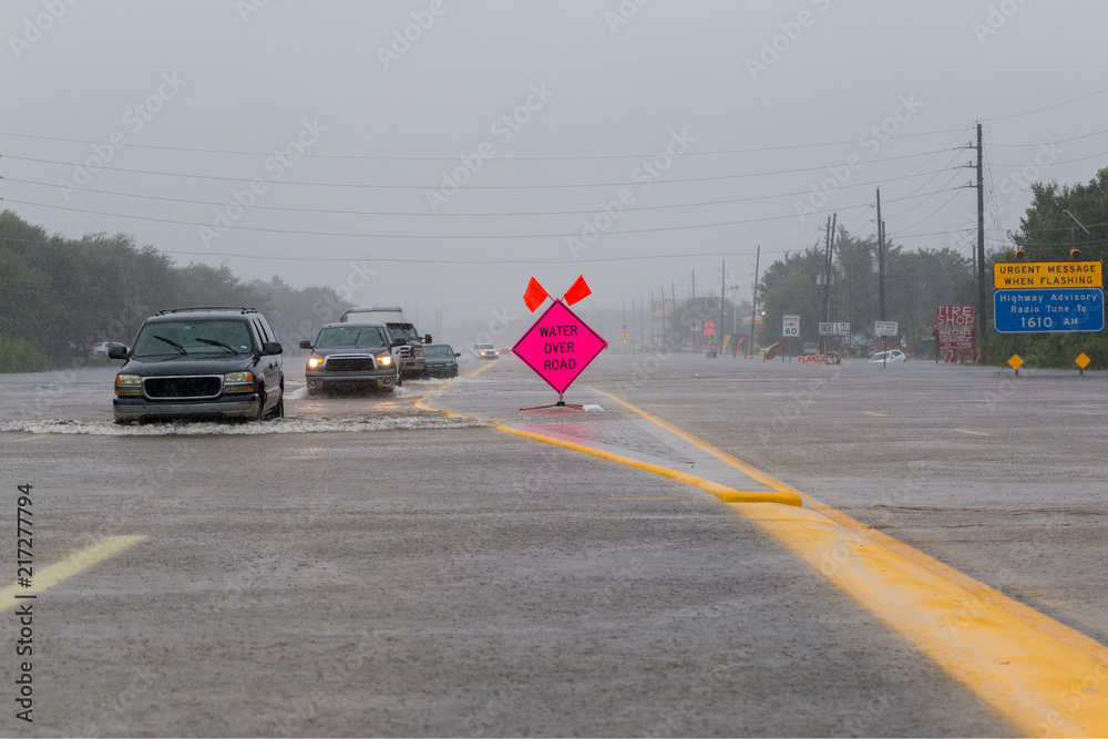 Cars drive on flooded highway. Heavy rains from hurricane caused many ...