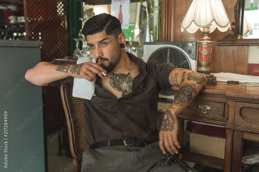 Vintage men tattooing and posing in a retro bar Stock Photo | Adobe Stock