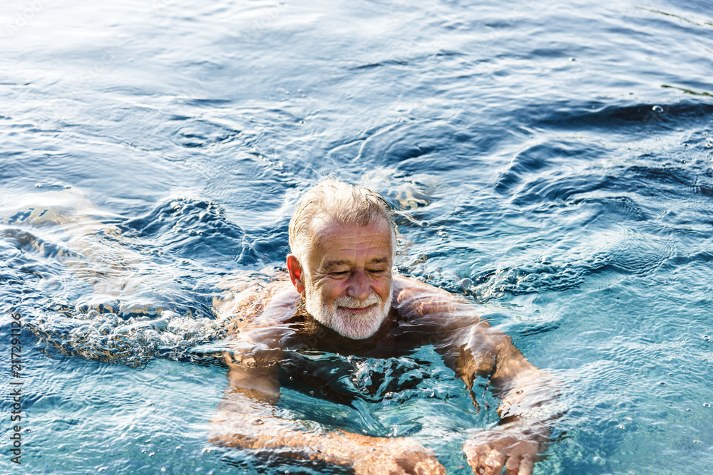 Senior man chilling in swimming pool Stock Photo | Adobe Stock