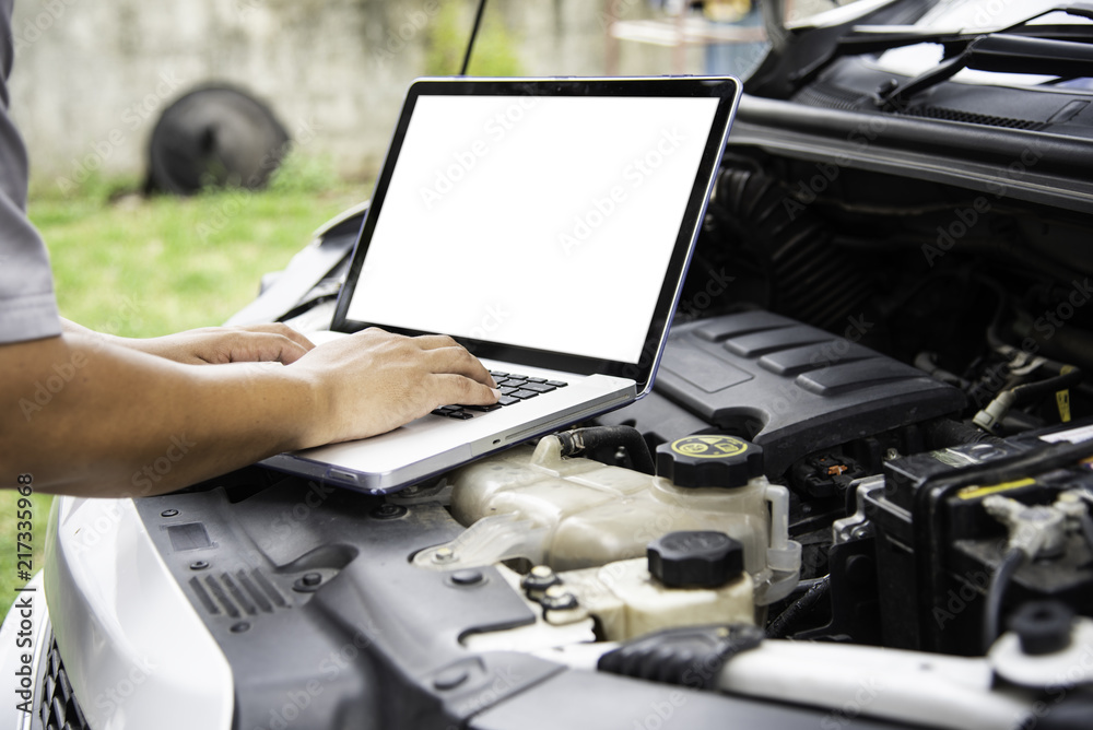 Professional mechanic checking car engine search for data with laptop ...