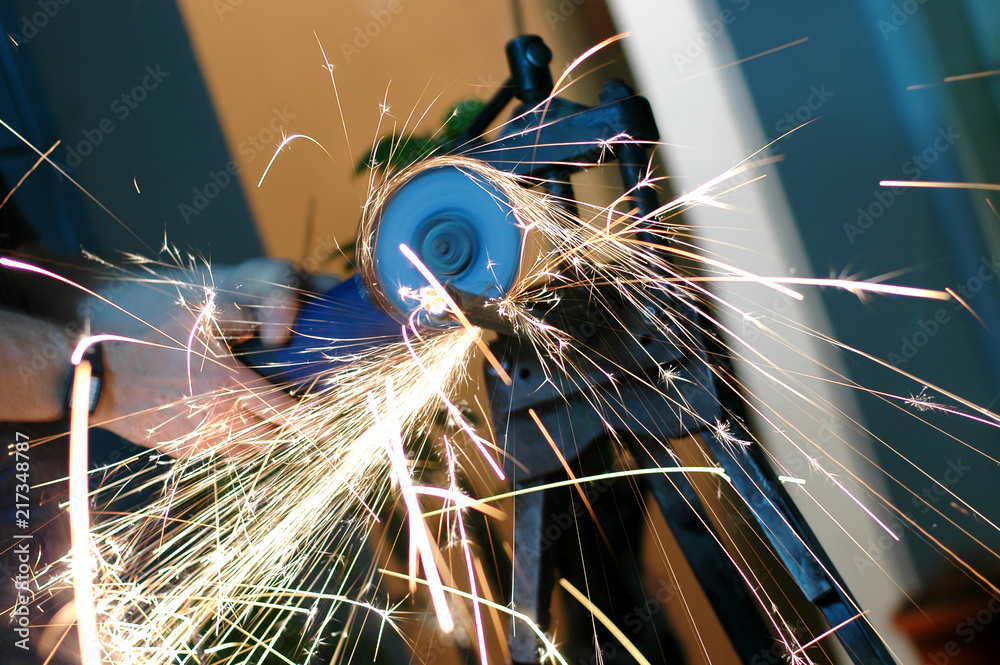 Angle grinder in use, cutting pipes for waterwork. Stock Photo | Adobe ...