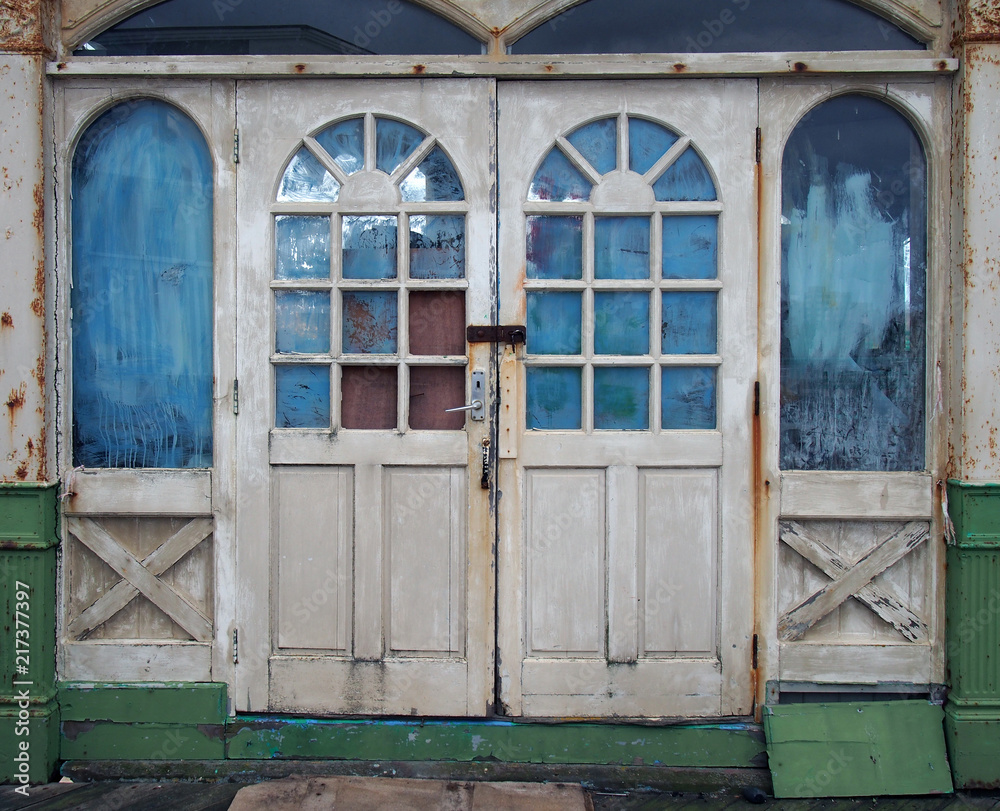 white wooden doors in an abandoned derelict house with broken and ...