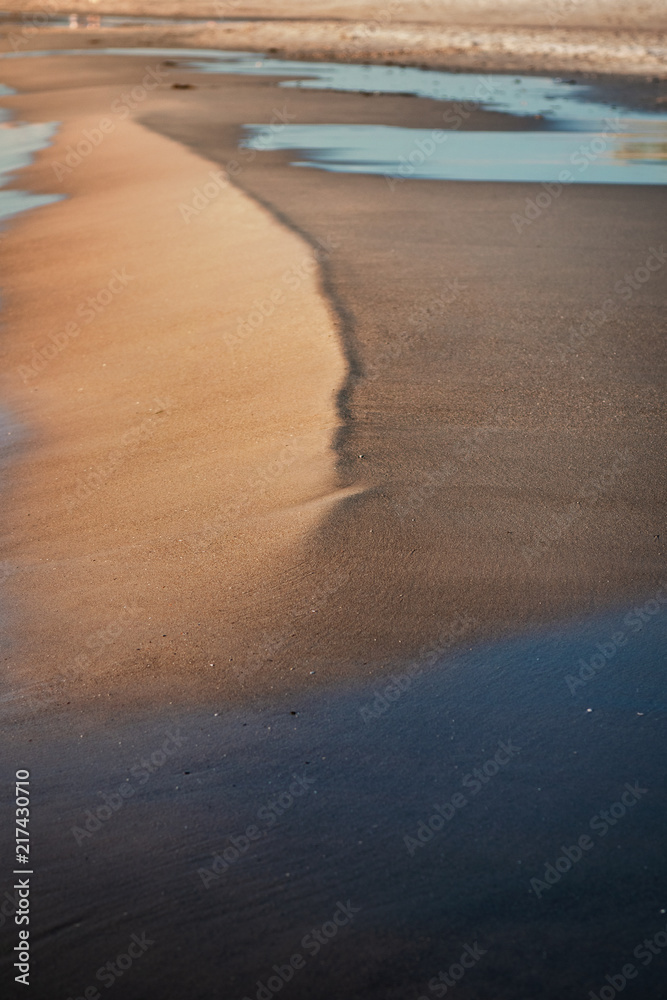 Line in the sand on the beach creating a sculptural shape with texture ...